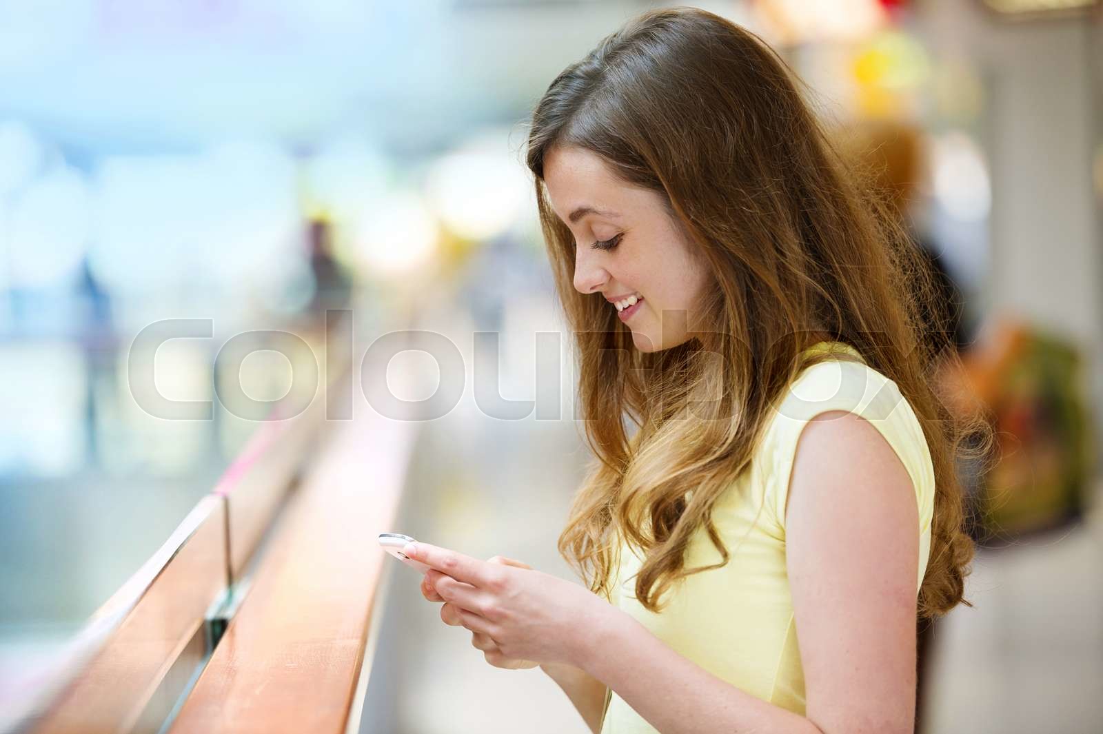 Shopping girl with smartphone | Stock image | Colourbox