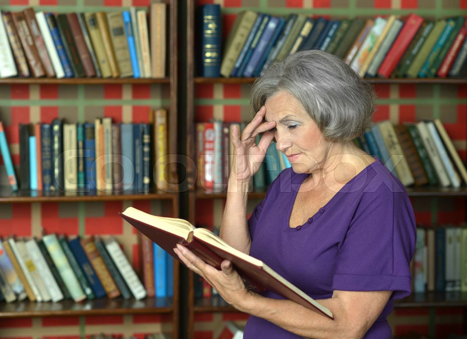 elderly woman with book | Stock image | Colourbox