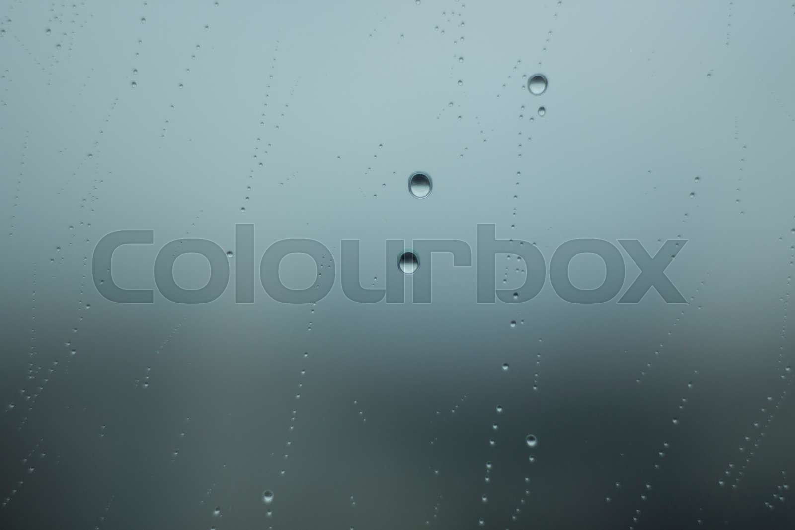 Raindrops on window gray rainy day | Stock image | Colourbox