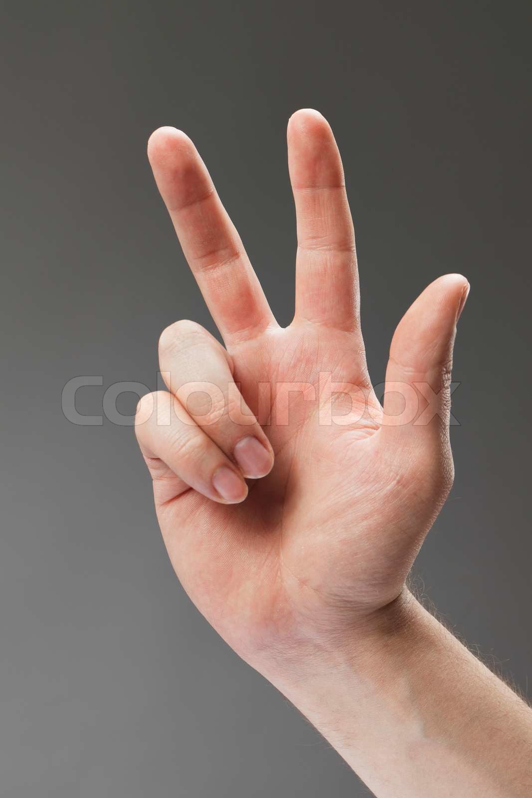 Hand of a man with three fingers pointing | Stock image | Colourbox