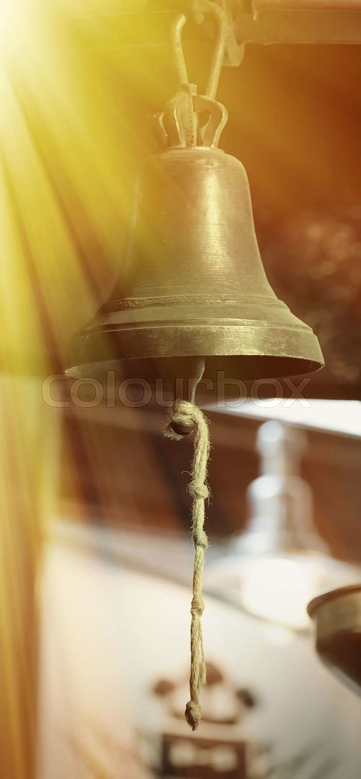 metal bell hanged up with rope | Stock image | Colourbox