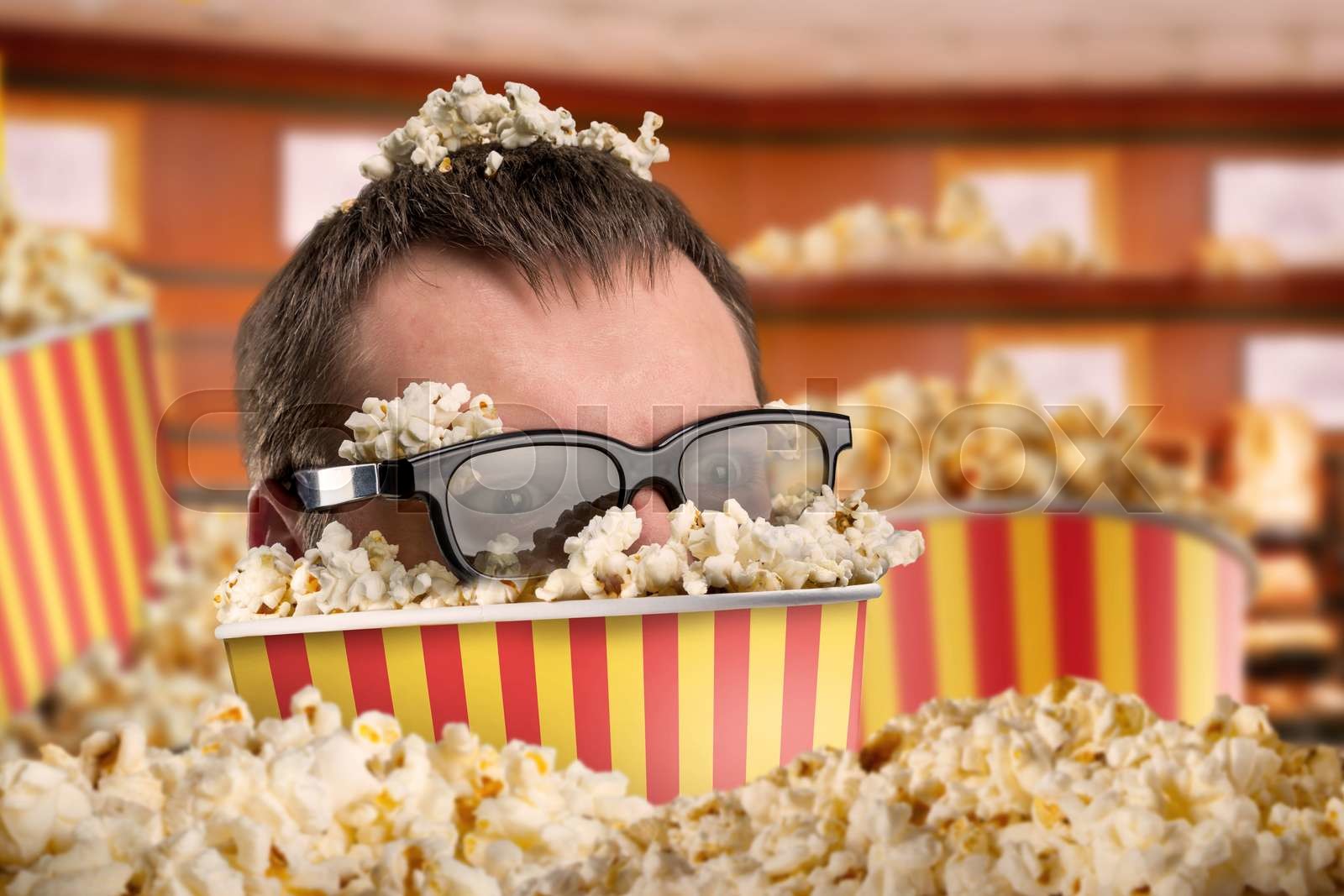 Man's in a bucket of popcorn | Stock image | Colourbox