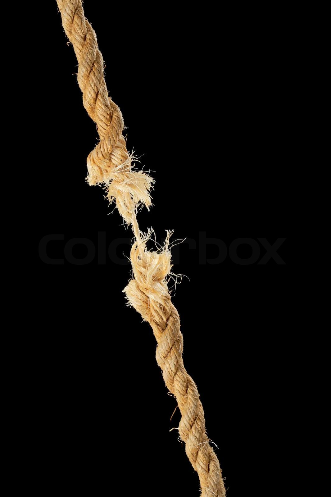 A rope breaking with a black background | Stock image | Colourbox