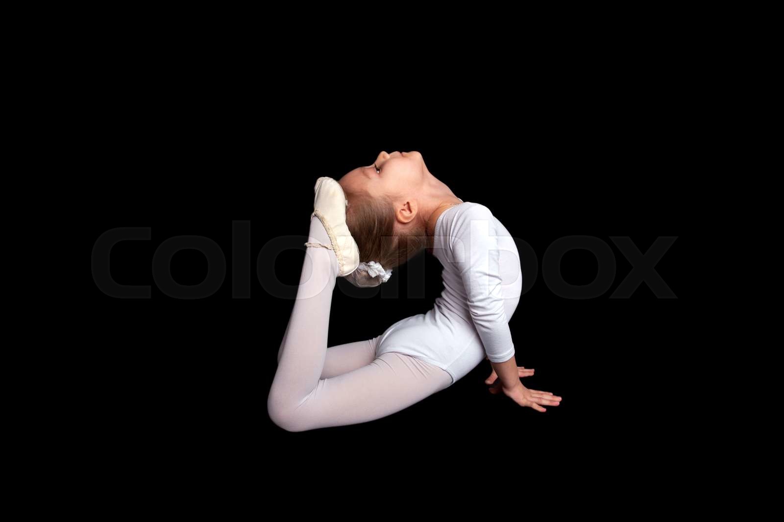 Little ballerina doing gymnastic stretching. | Stock image | Colourbox