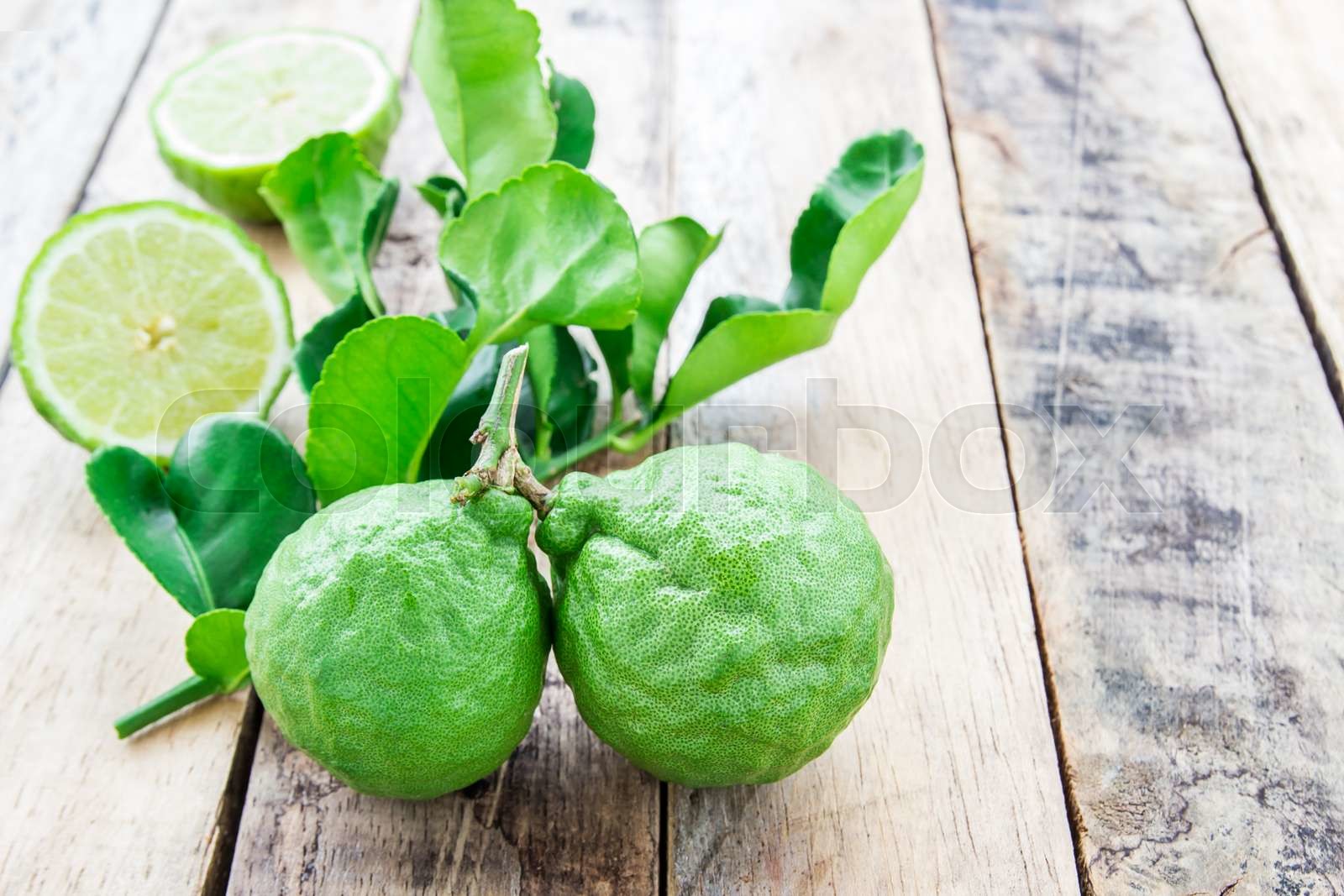 Bergamot on wooden table, (Kaffir lime) | Stock image | Colourbox