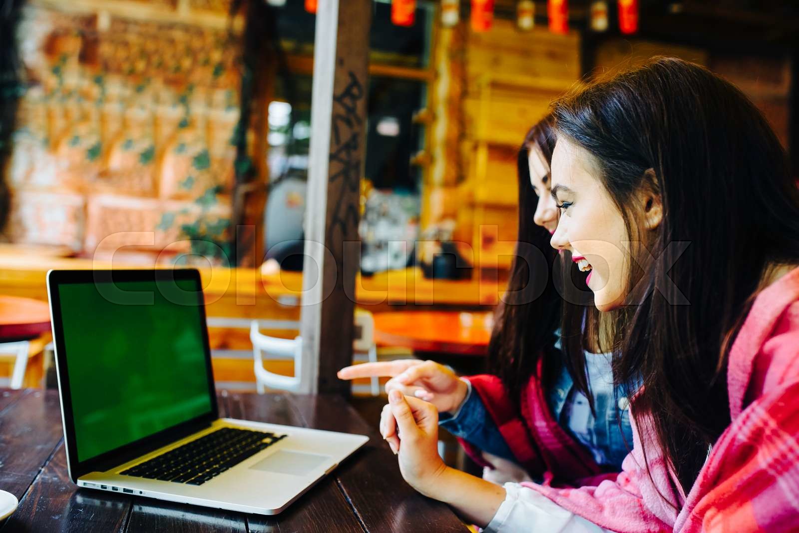 two girls watching something in laptop | Stock image | Colourbox