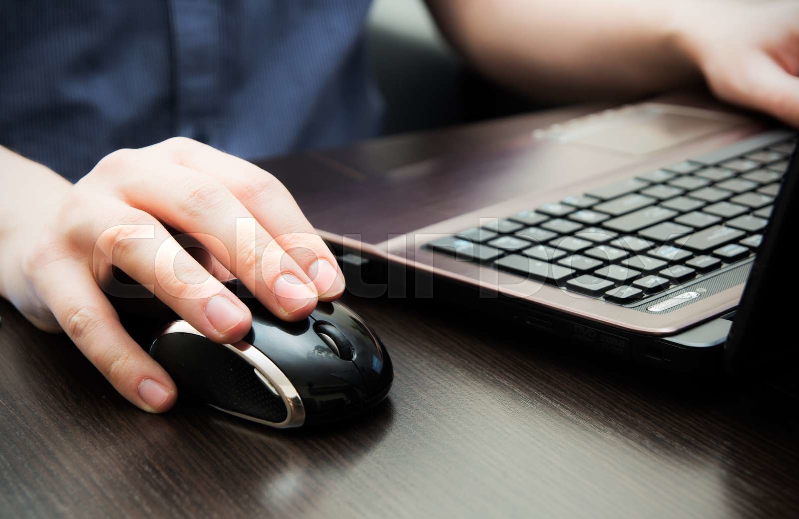 Human hand on computer mouse. Laptop on desk. | Stock image | Colourbox