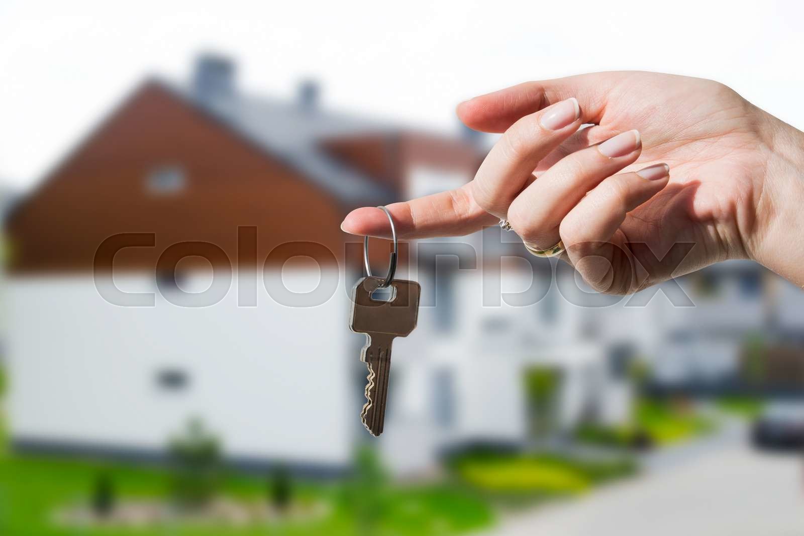 Woman's hand holding keys to new house | Stock image | Colourbox