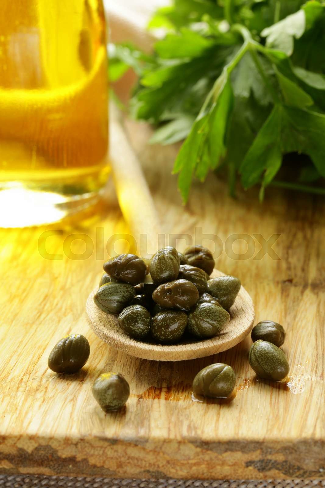 Pickled capers in a wooden spoon | Stock image | Colourbox
