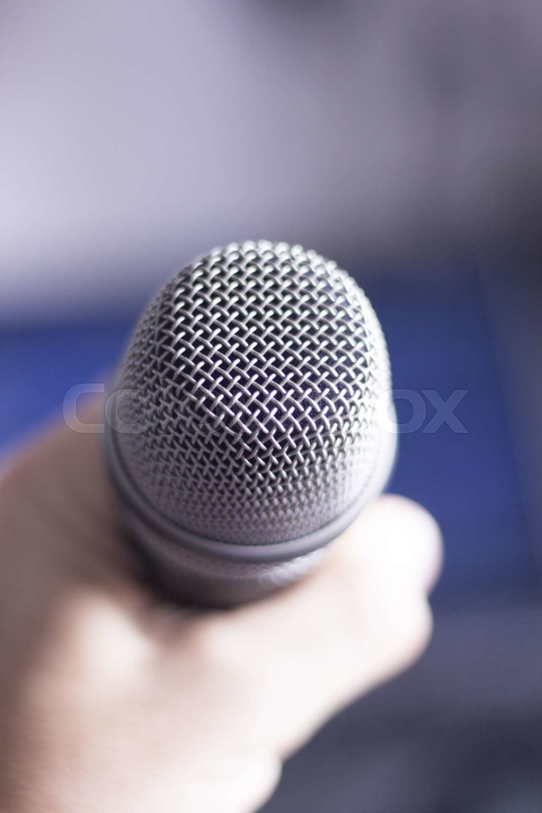 Professional microphone held in hand | Stock image | Colourbox