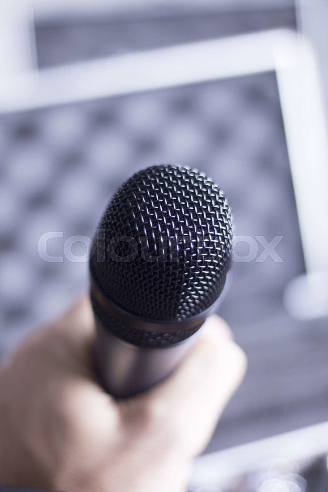 Professional microphone held in hand | Stock image | Colourbox