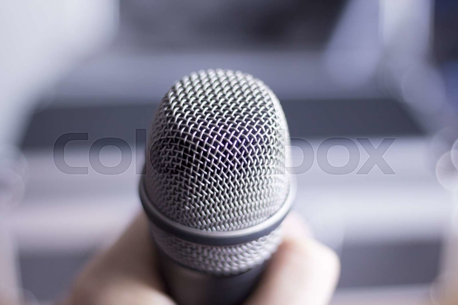 Professional microphone held in hand | Stock image | Colourbox