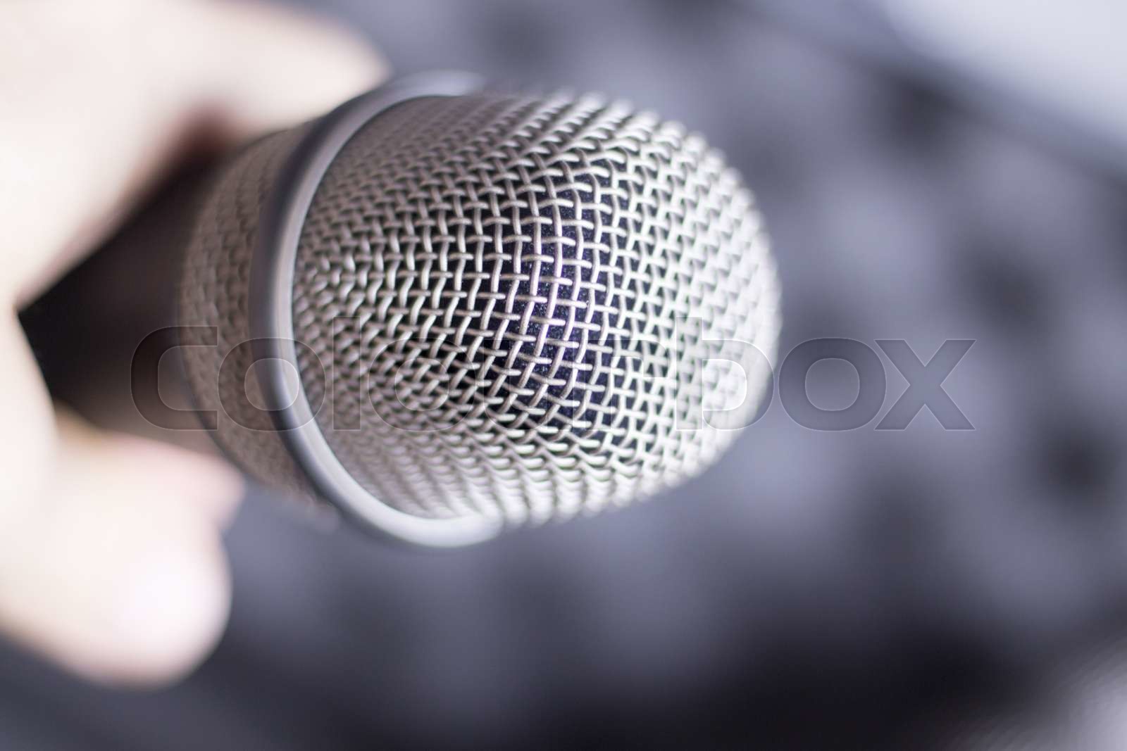 Professional microphone held in hand | Stock image | Colourbox