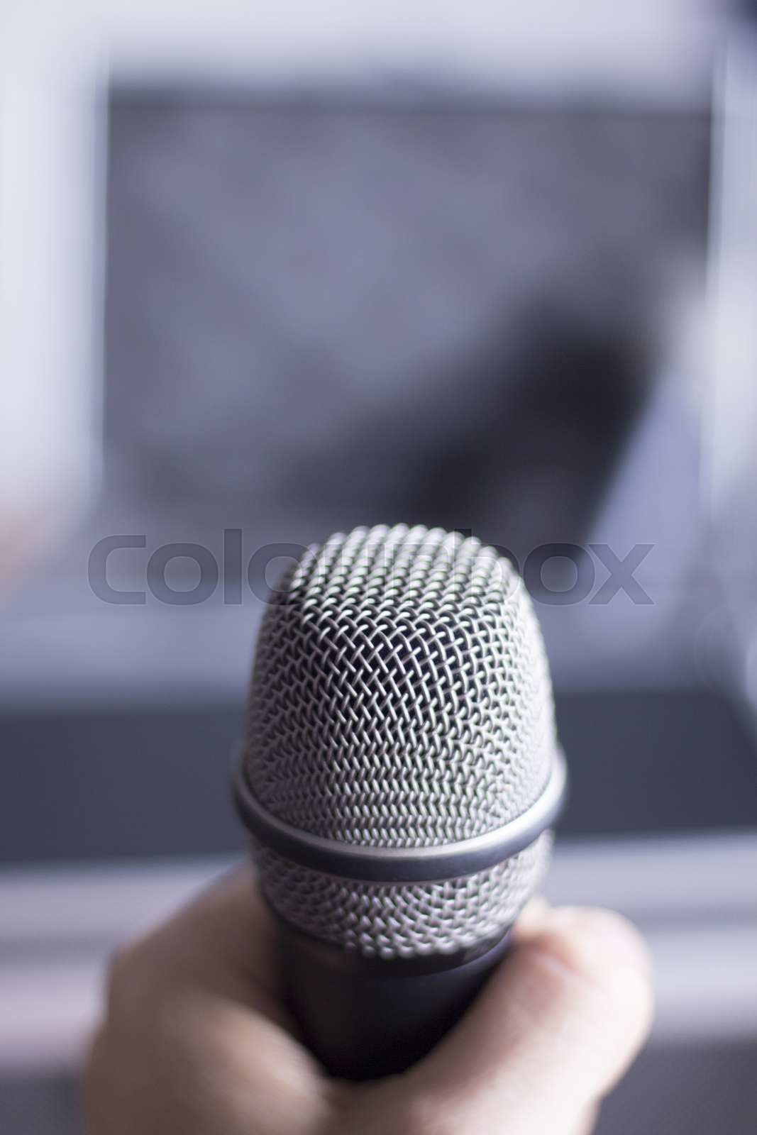 Professional microphone held in hand | Stock image | Colourbox