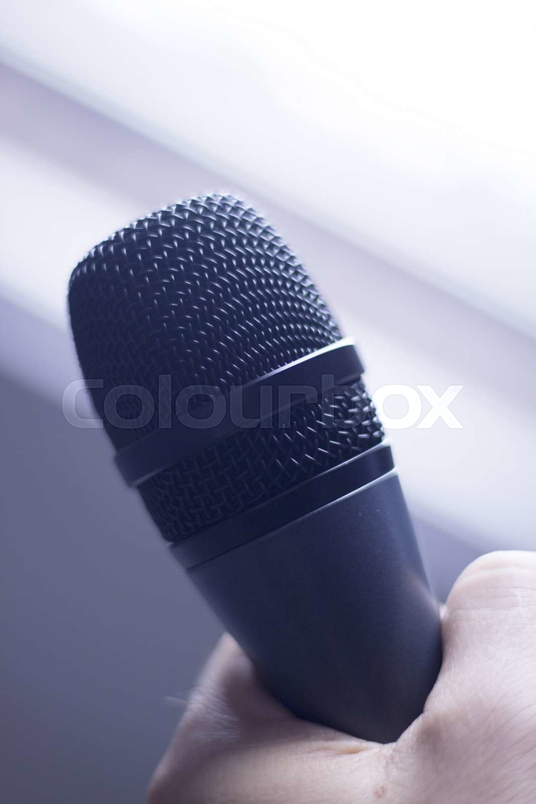 Professional microphone held in hand | Stock image | Colourbox