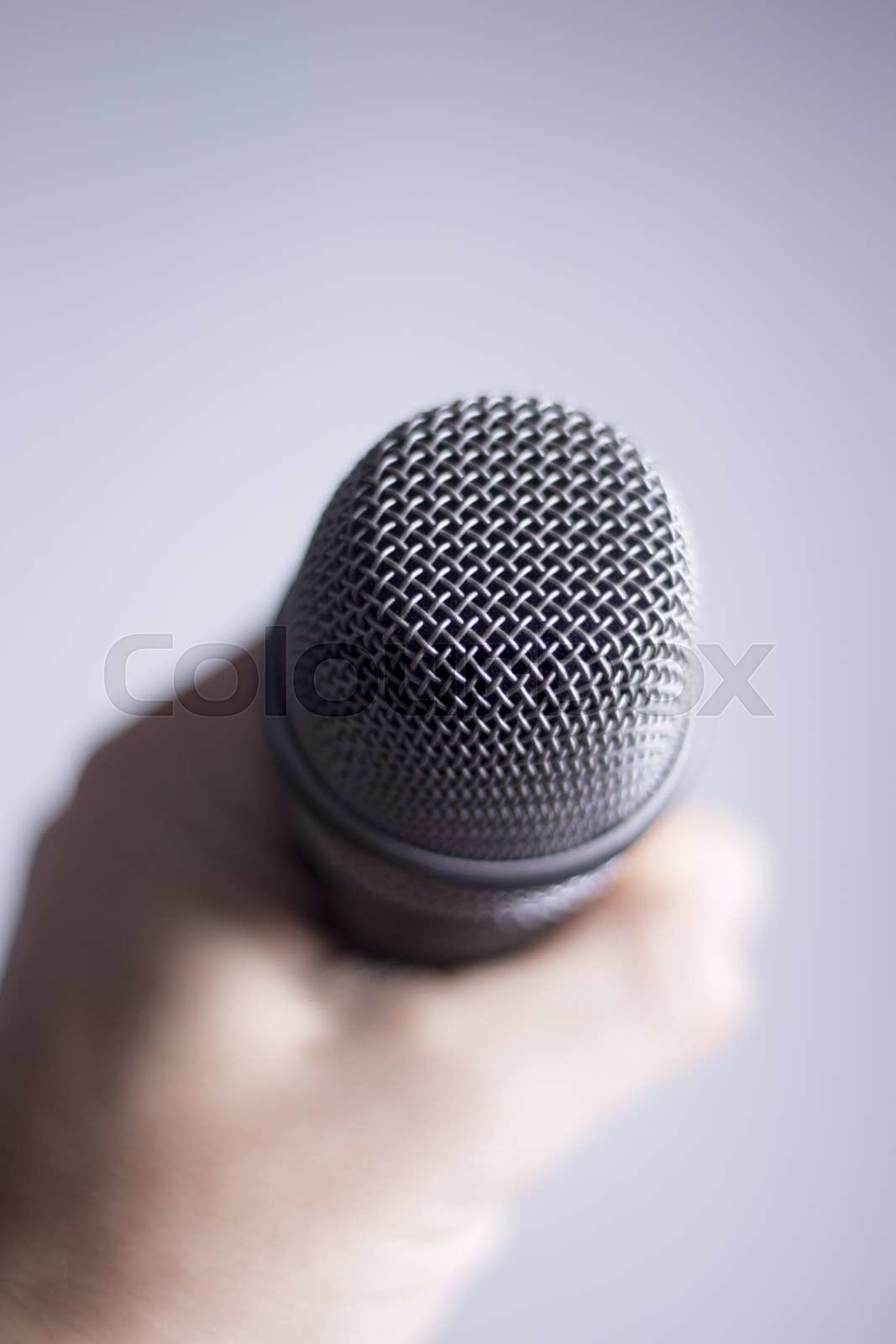 Professional microphone held in hand | Stock image | Colourbox