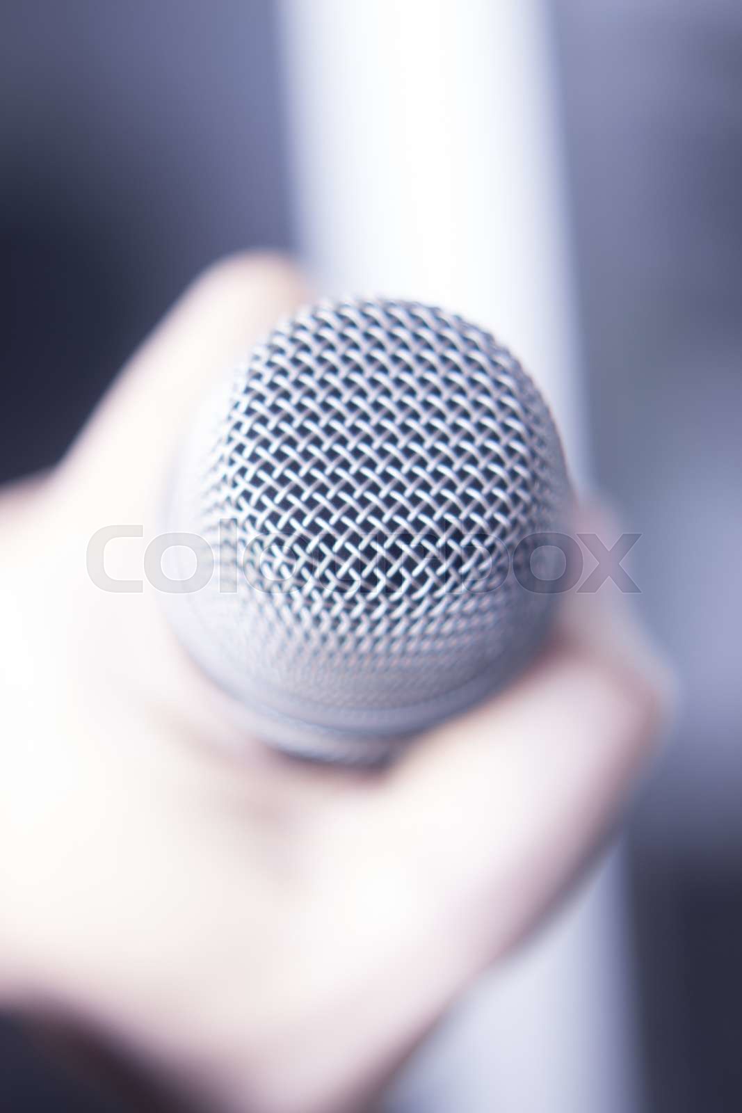 Professional microphone held in hand | Stock image | Colourbox