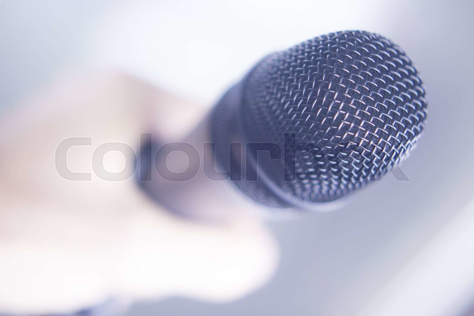 Professional microphone held in hand | Stock image | Colourbox