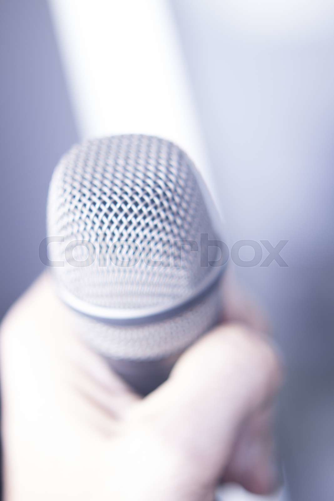 Professional microphone held in hand | Stock image | Colourbox