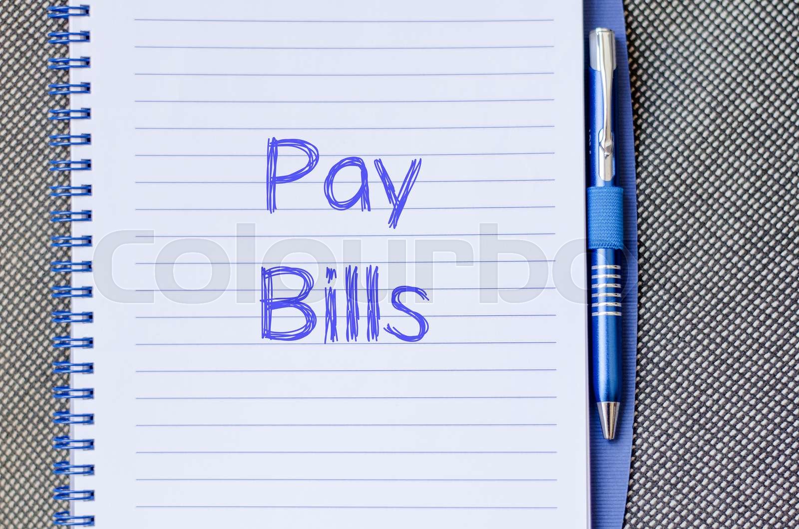 Pay bills write on notebook | Stock image | Colourbox