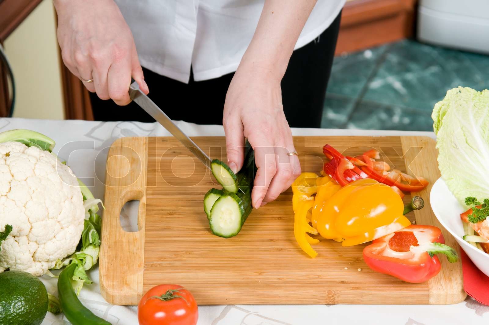 Cutting of vegetables on a chopping board | Stock image | Colourbox