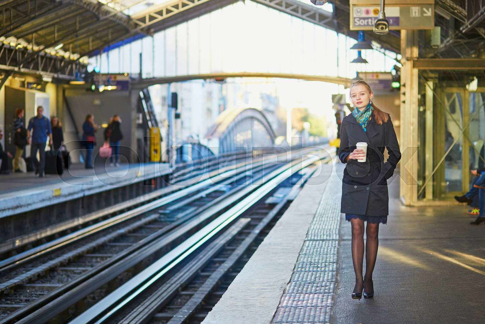 Beautiful young woman waiting for a train in Parisian underground ...