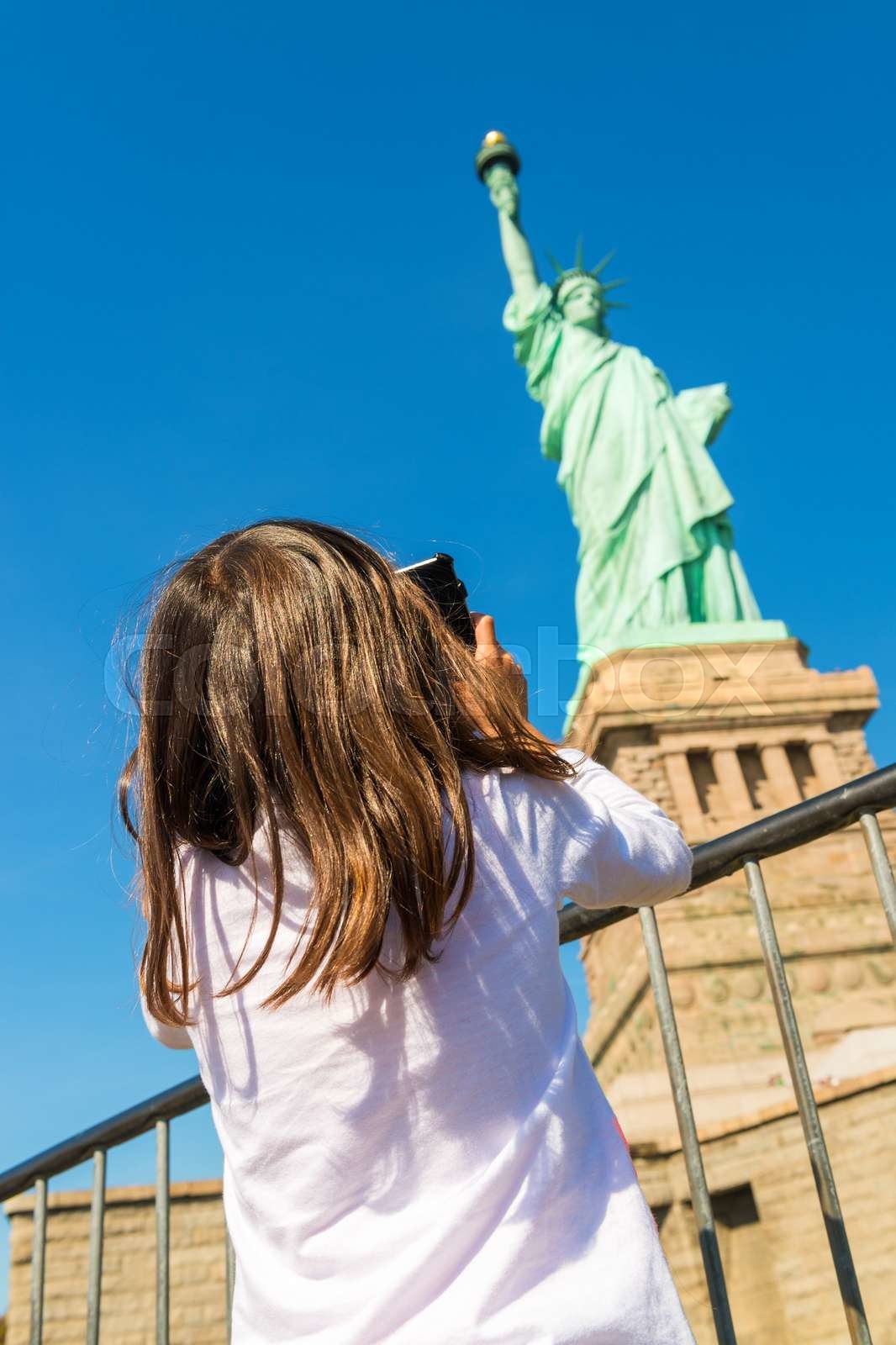 Kid photographing Statue of Liberty | Stock image | Colourbox