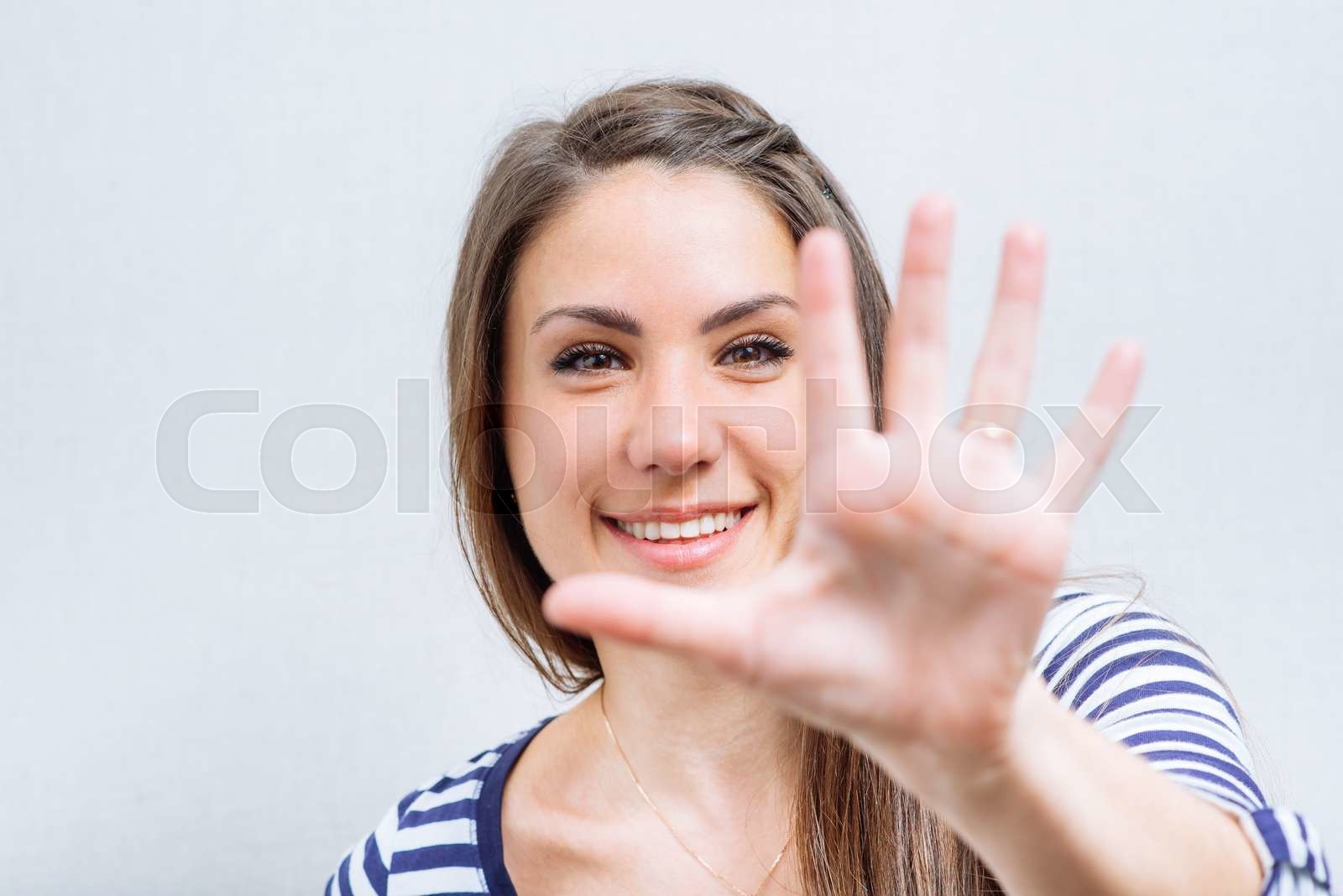 pretty girl waving | Stock image | Colourbox