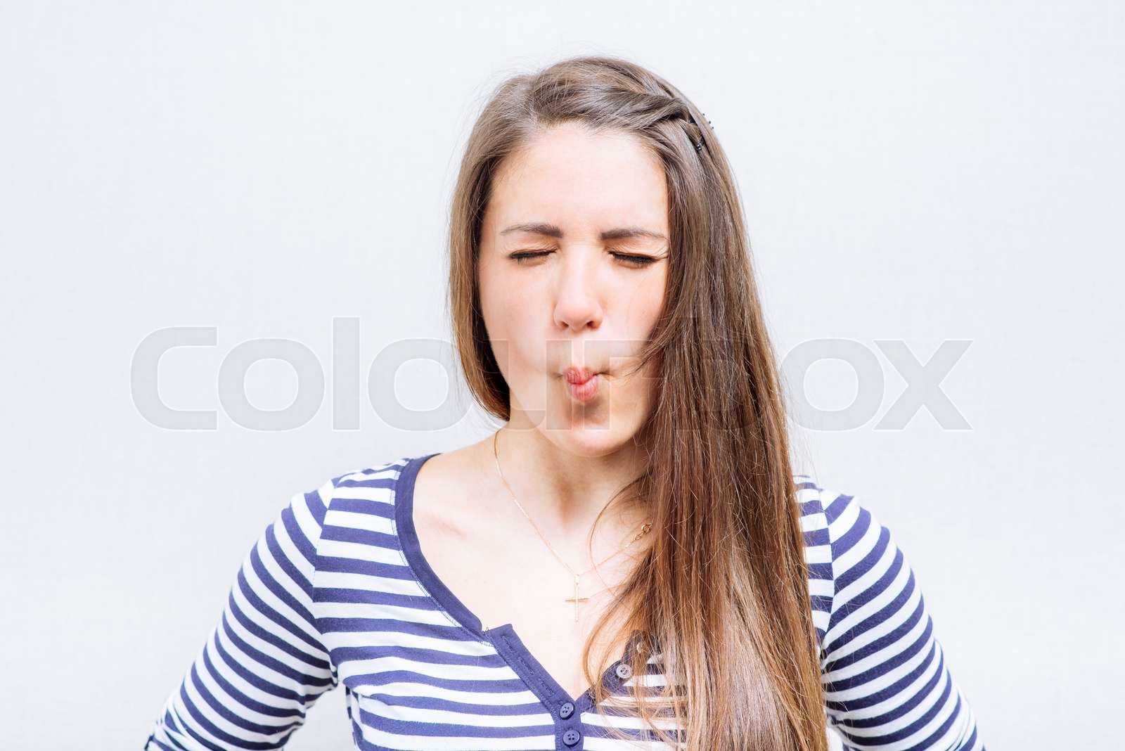 Young woman squeezing cheeks | Stock image | Colourbox