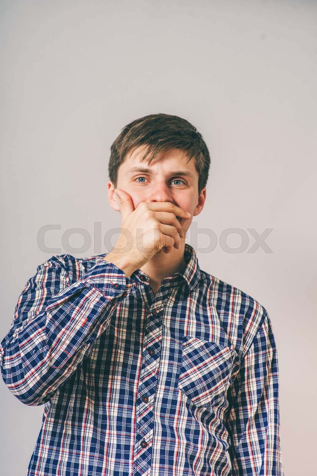 man laughing covering his mouth with hands | Stock image | Colourbox