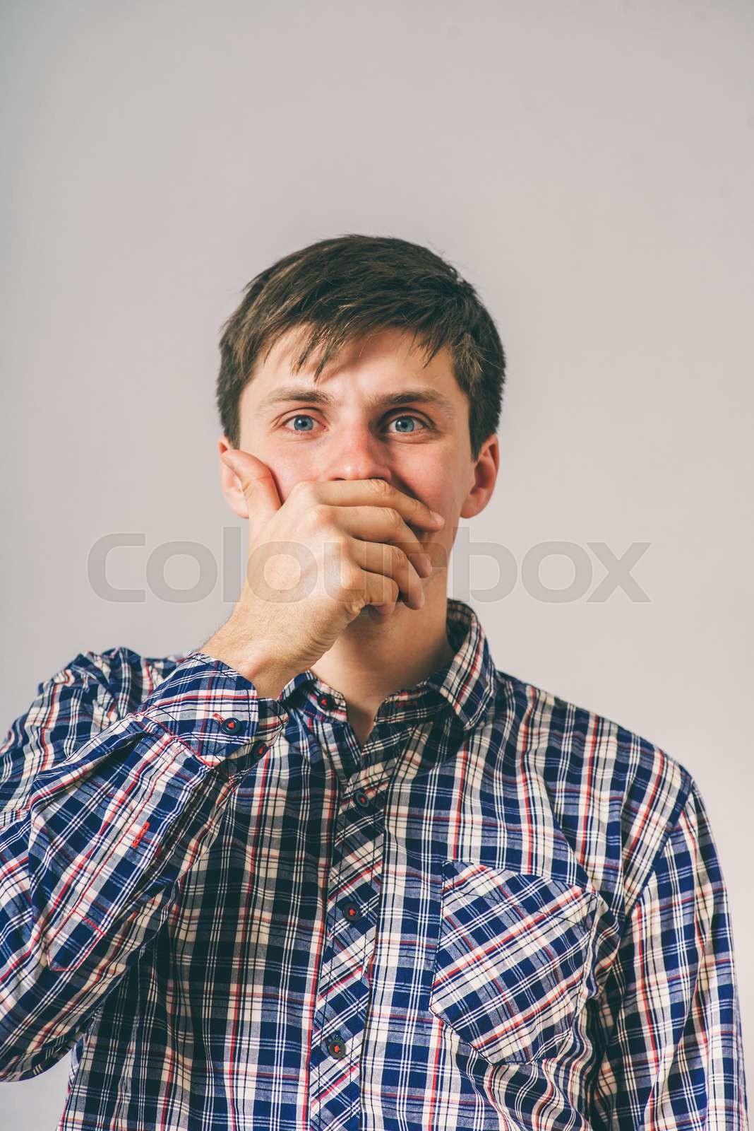man laughing covering his mouth with hands | Stock image | Colourbox
