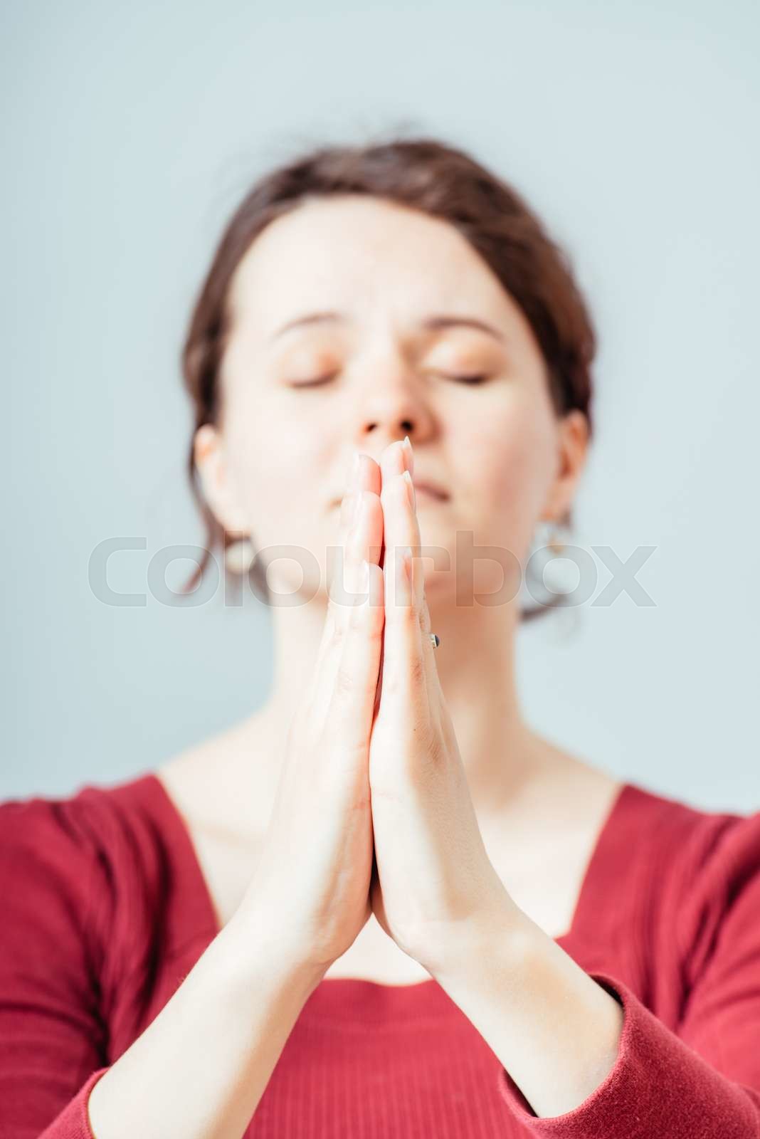 beautiful brunette girl praying | Stock image | Colourbox