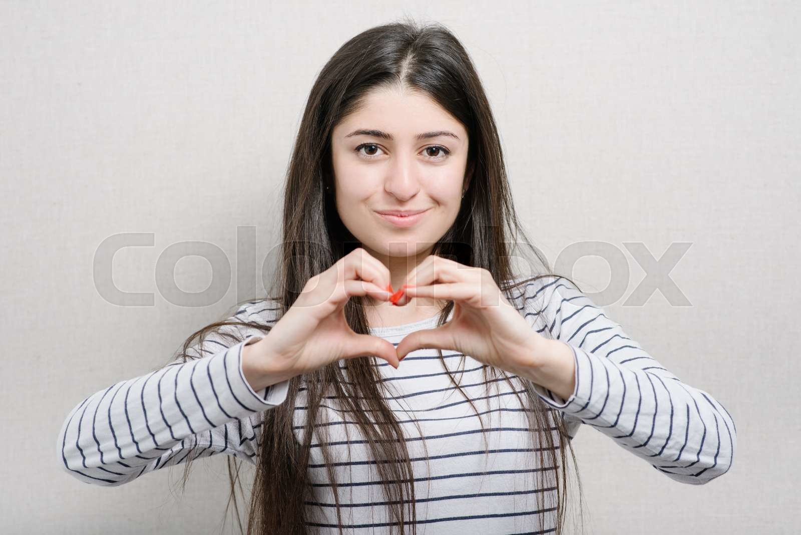 Girl shows heart hands | Stock image | Colourbox