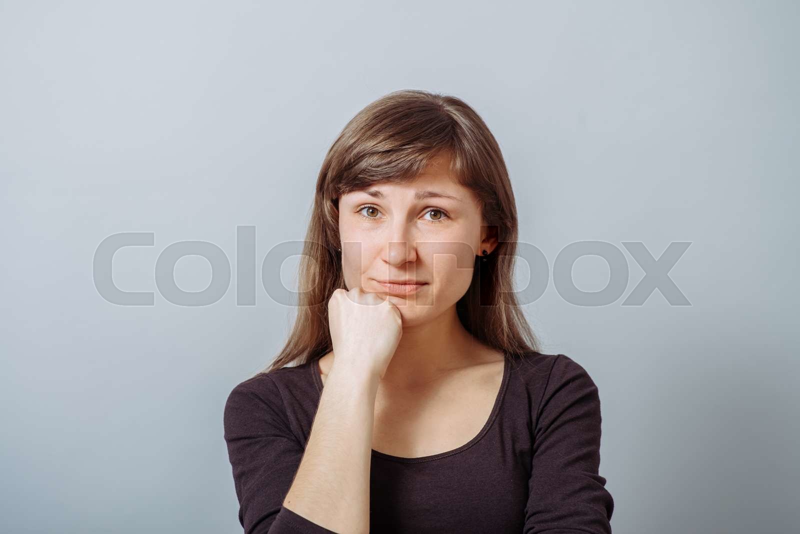 girl props up fists chin | Stock image | Colourbox