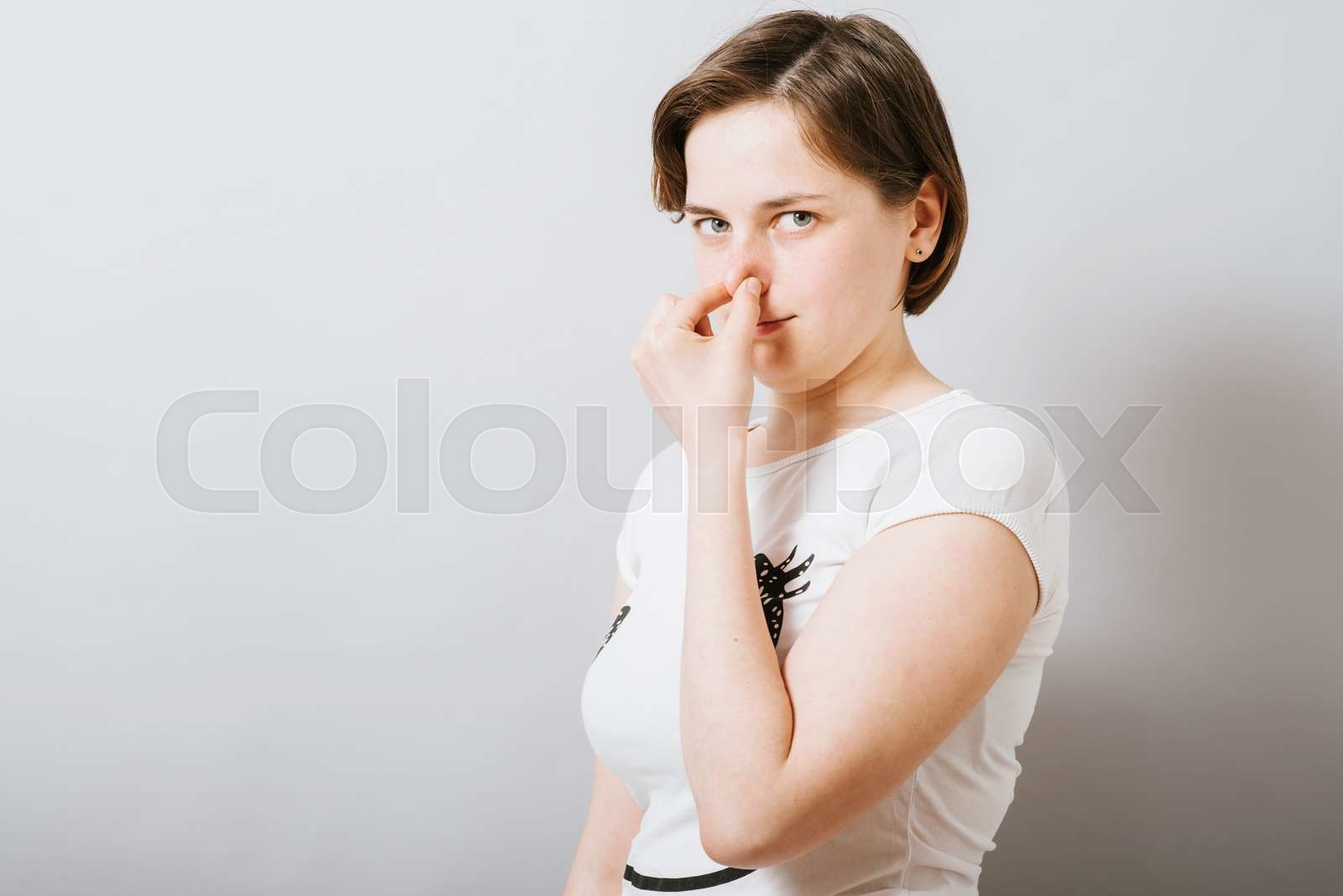 girl closes nose hand | Stock image | Colourbox