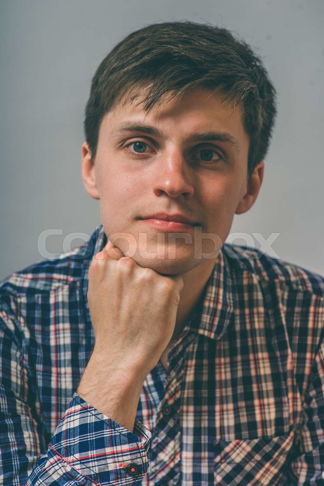 man propped his chin with his fist | Stock image | Colourbox