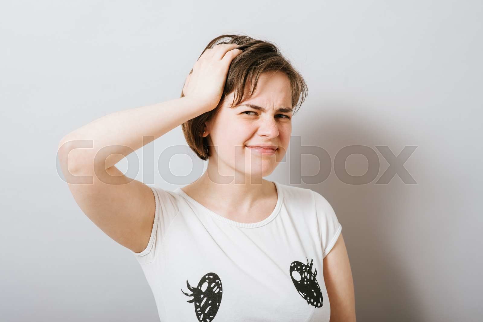 girl scratching back of the head | Stock image | Colourbox