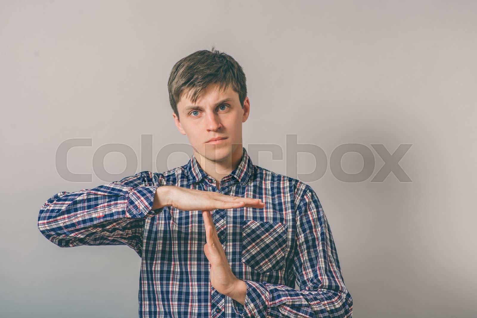 man shows a timeout | Stock image | Colourbox