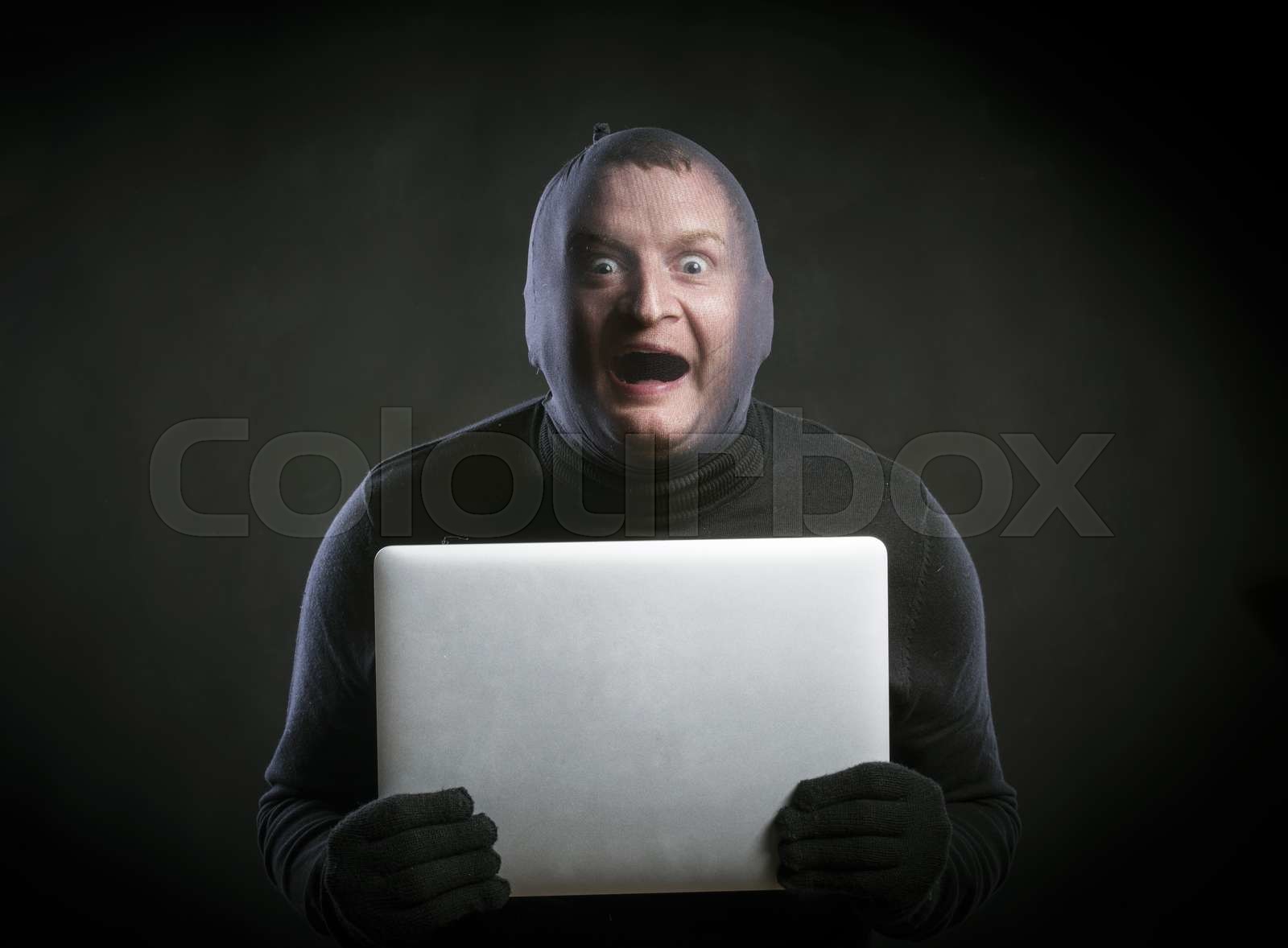 Thief in black mask | Stock image | Colourbox