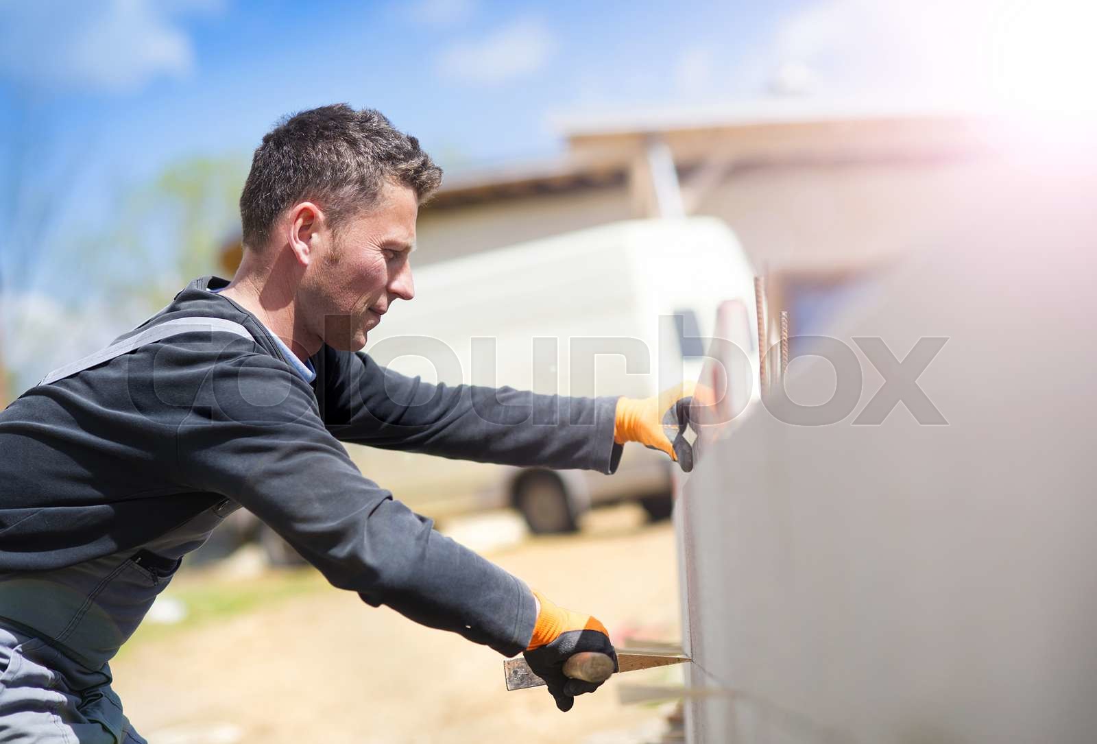 Man building a house | Stock image | Colourbox