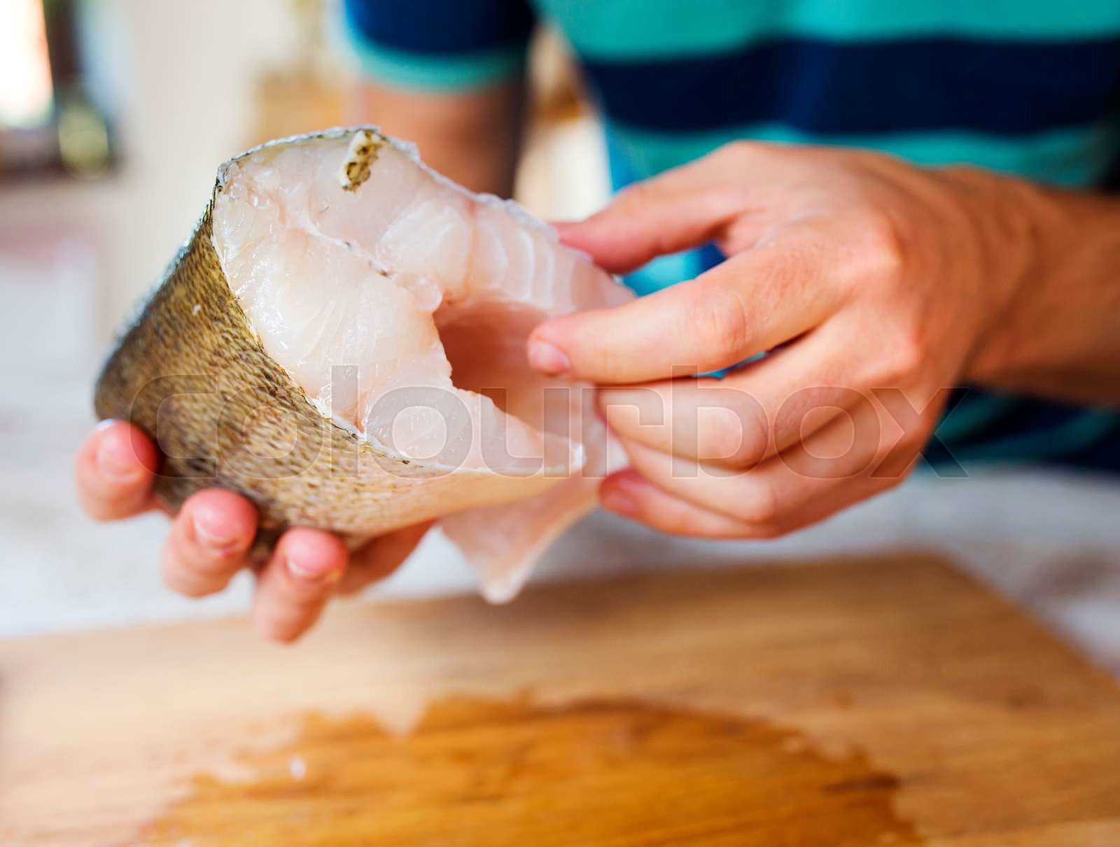 Man holding zander fillets | Stock image | Colourbox