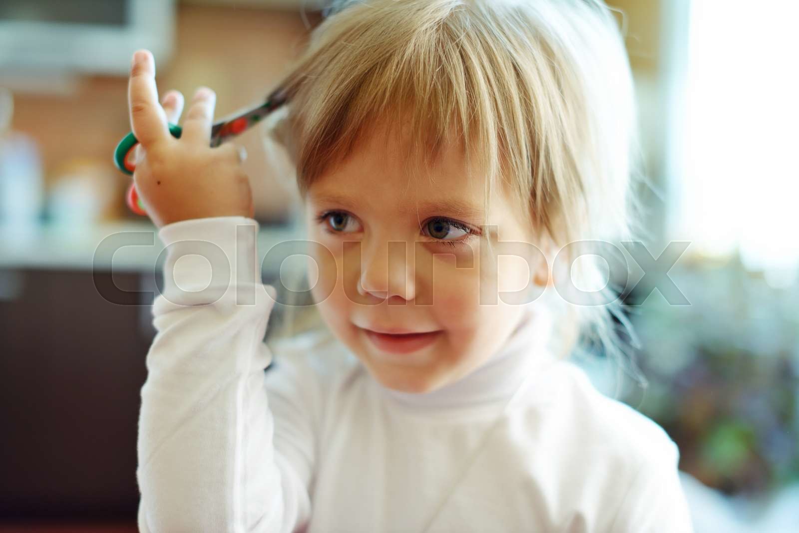 Cute little girl with scissors | Stock image | Colourbox