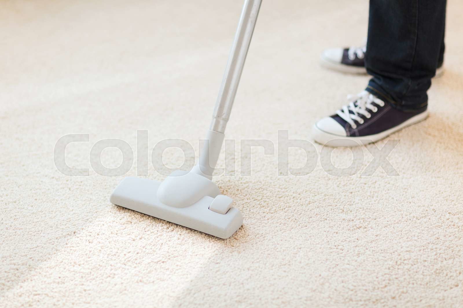 close up of male hoovering carpet | Stock image | Colourbox