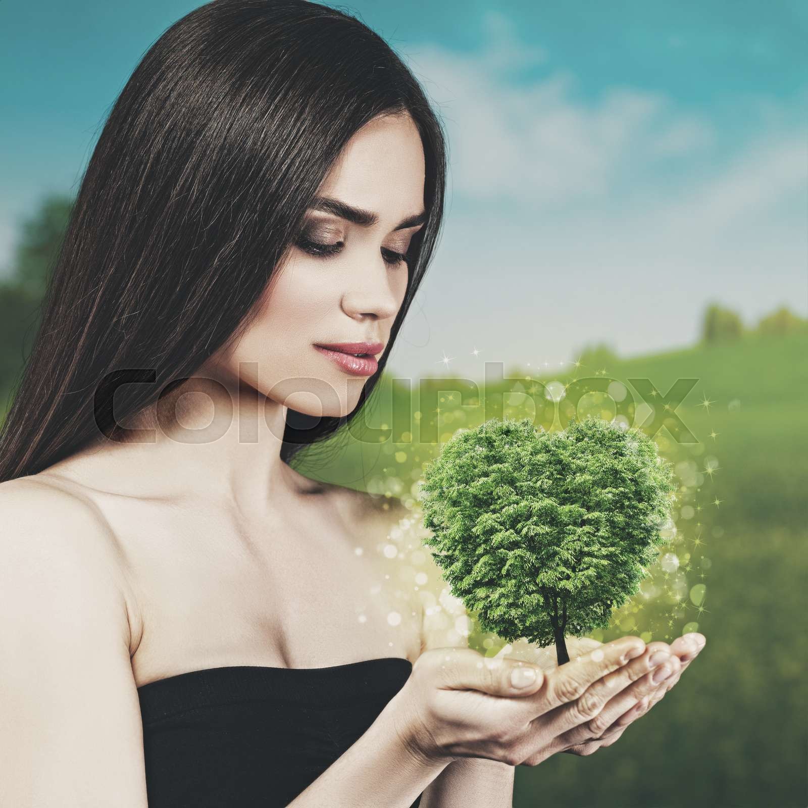 Beauty young woman with green tree in her hands | Stock image | Colourbox