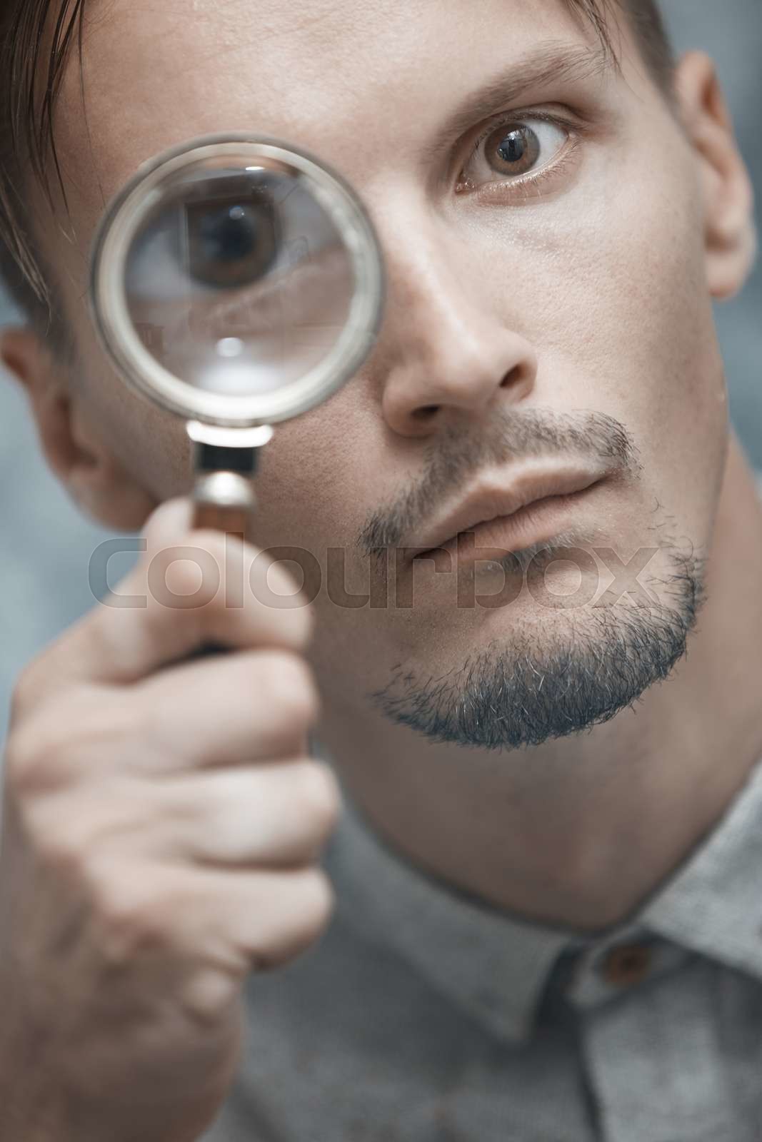 Man with magnifying glass | Stock image | Colourbox