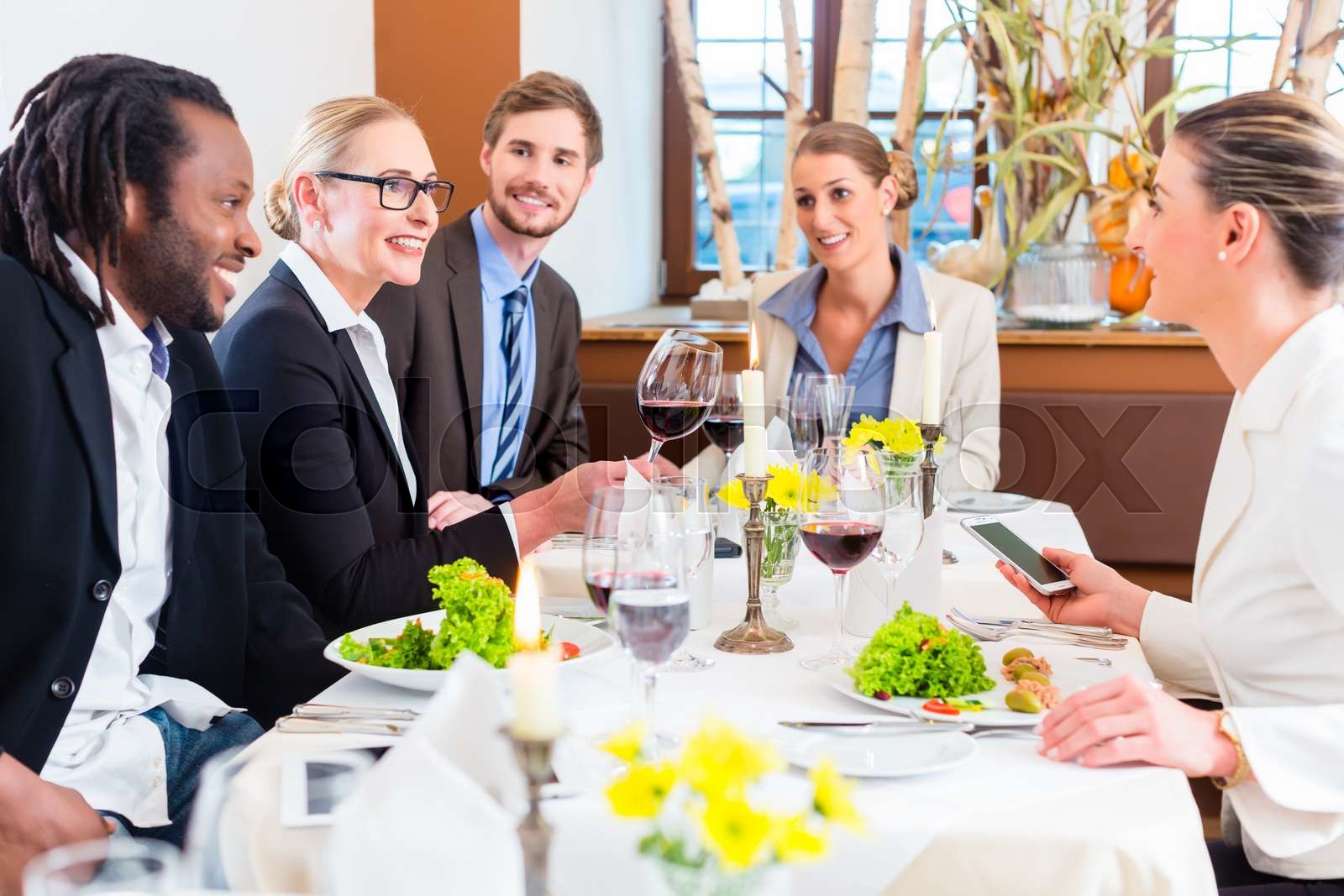 Team at business lunch meeting in restaurant | Stock image | Colourbox