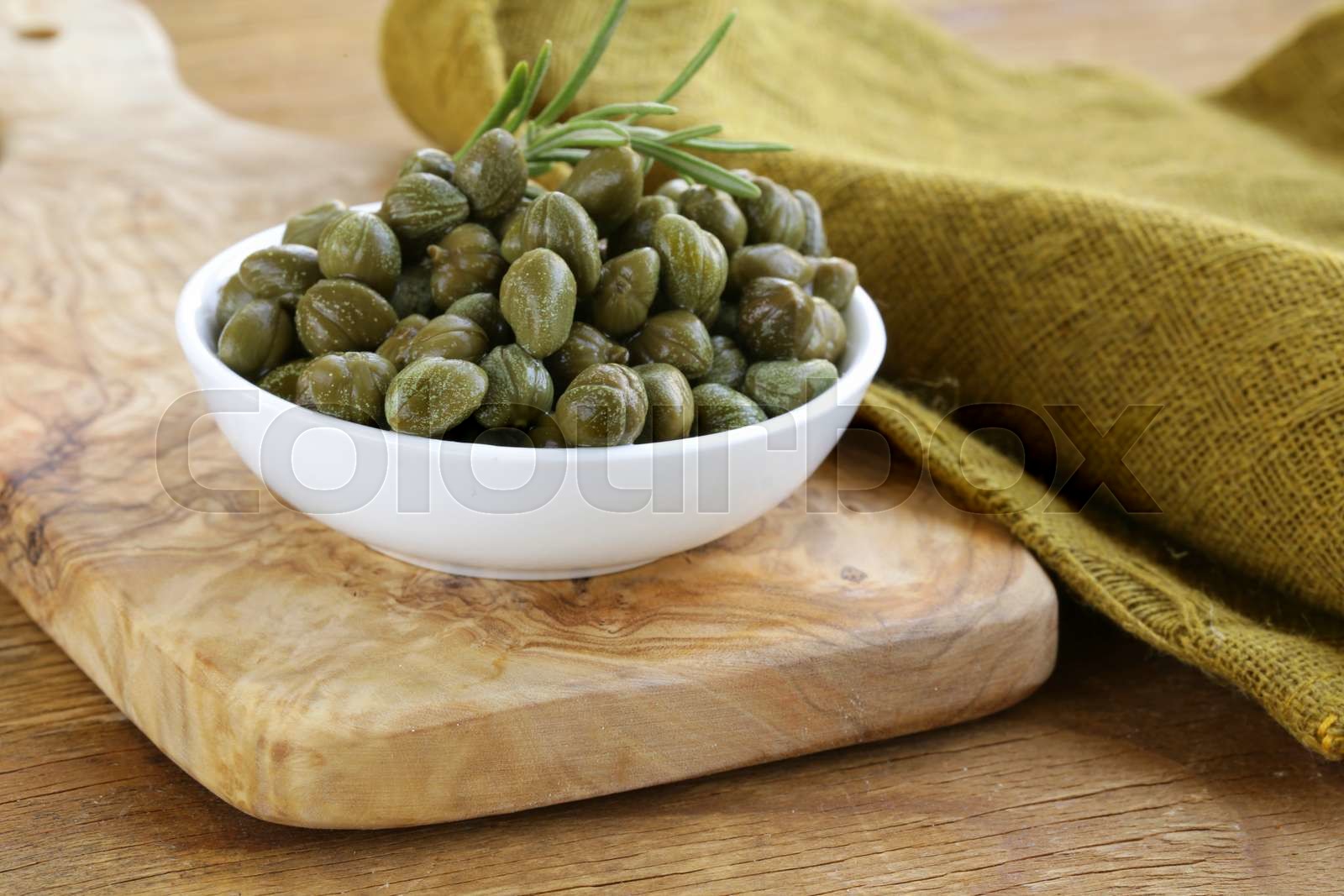 Pickled capers in white bowl | Stock image | Colourbox