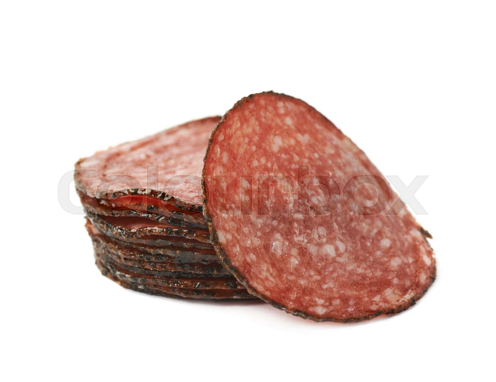 Pile of salami slices isolated | Stock image | Colourbox