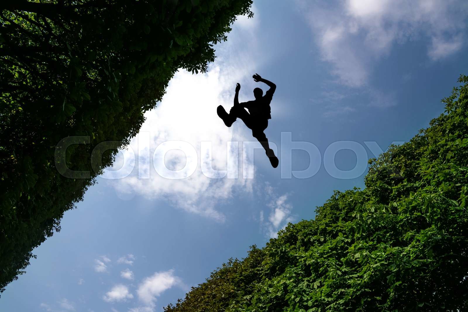 Man jumping over bushes | Stock image | Colourbox