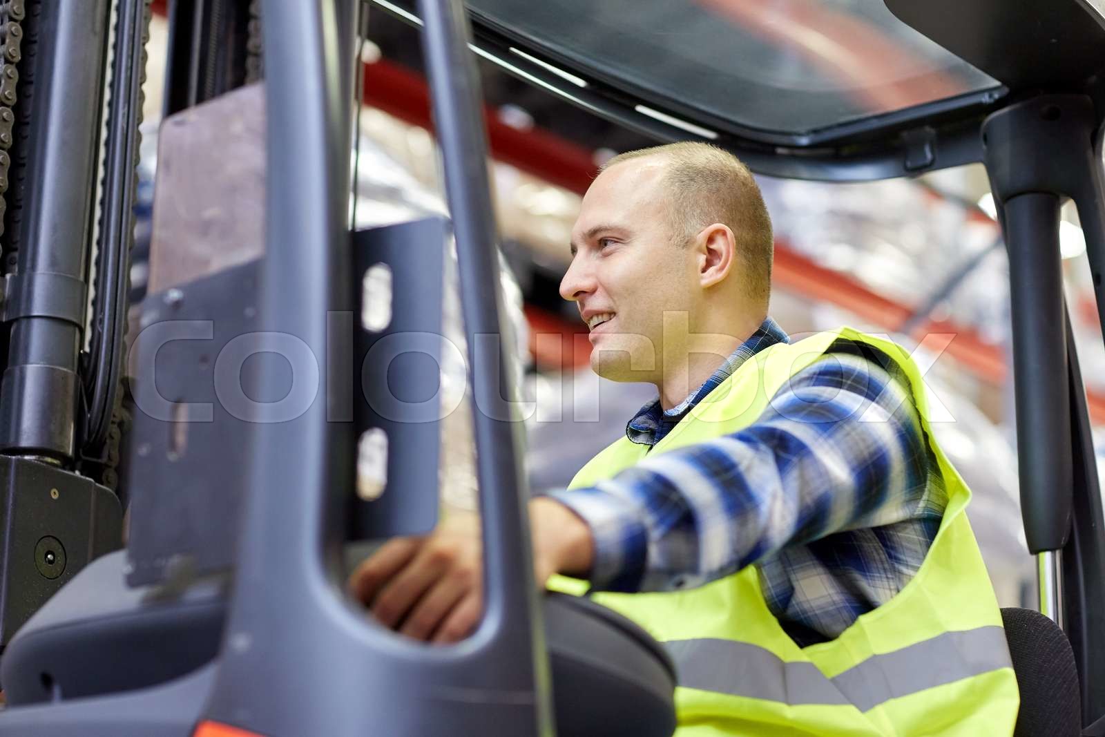 man operating forklift loader at warehouse | Stock image | Colourbox
